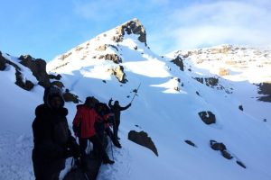 Why is Mount Kilimanjaro covered with snow at the summit?